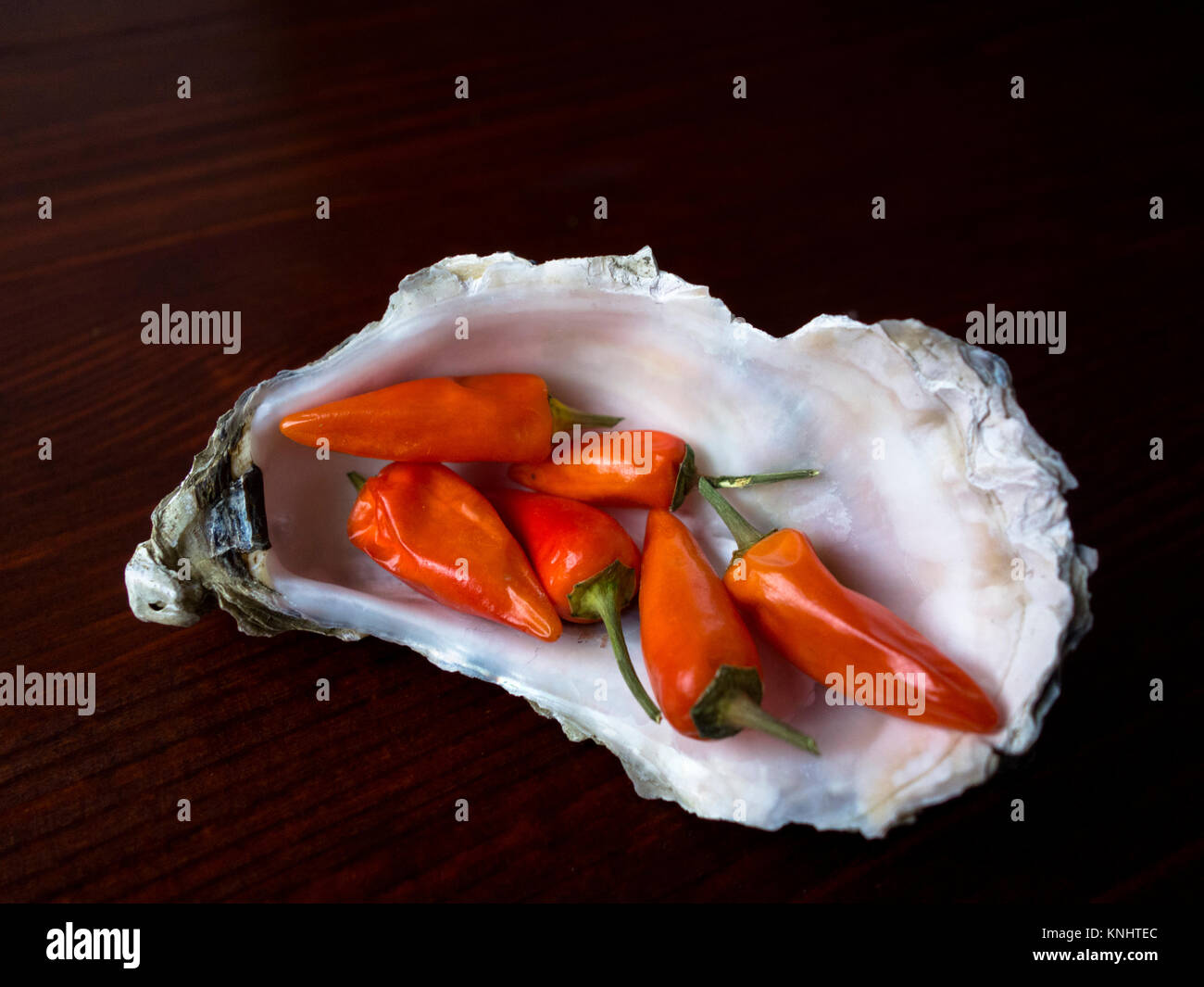 Baby chili peppers inside an oyster shell Stock Photo - Alamy