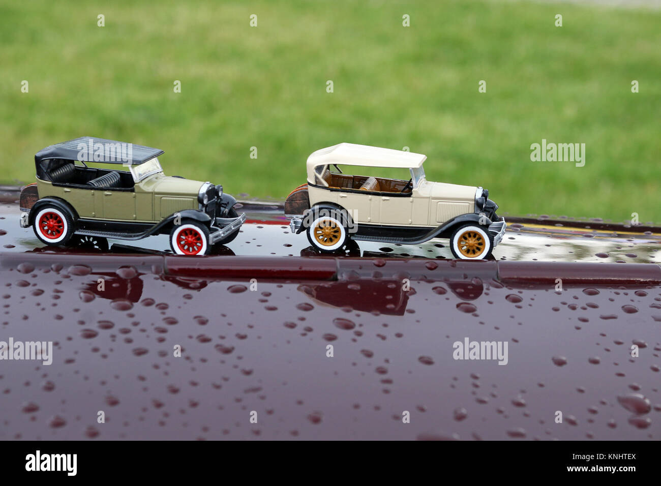 two small cars on the hood of the car Stock Photo - Alamy