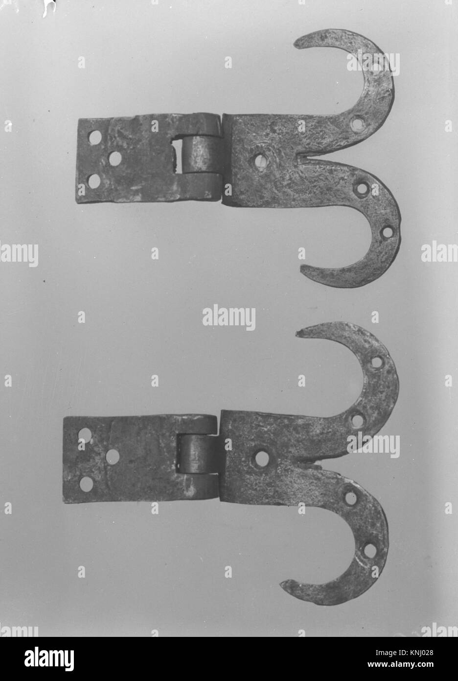 This hinge exemplifies historical metalwork, demonstrating ...