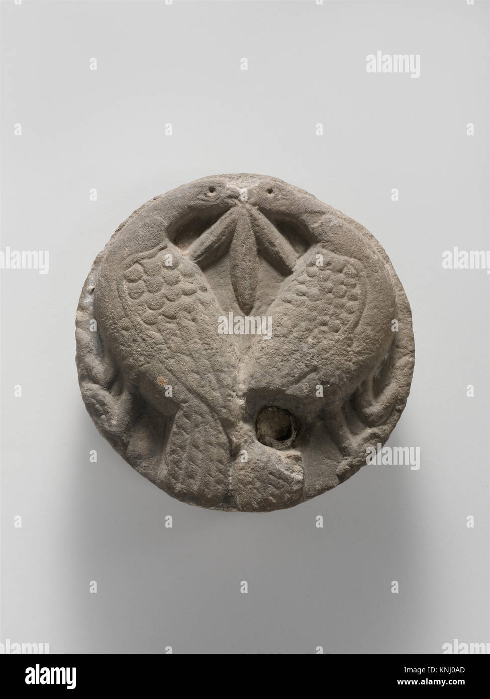 This decorative roundel features a detailed design, typical of ...