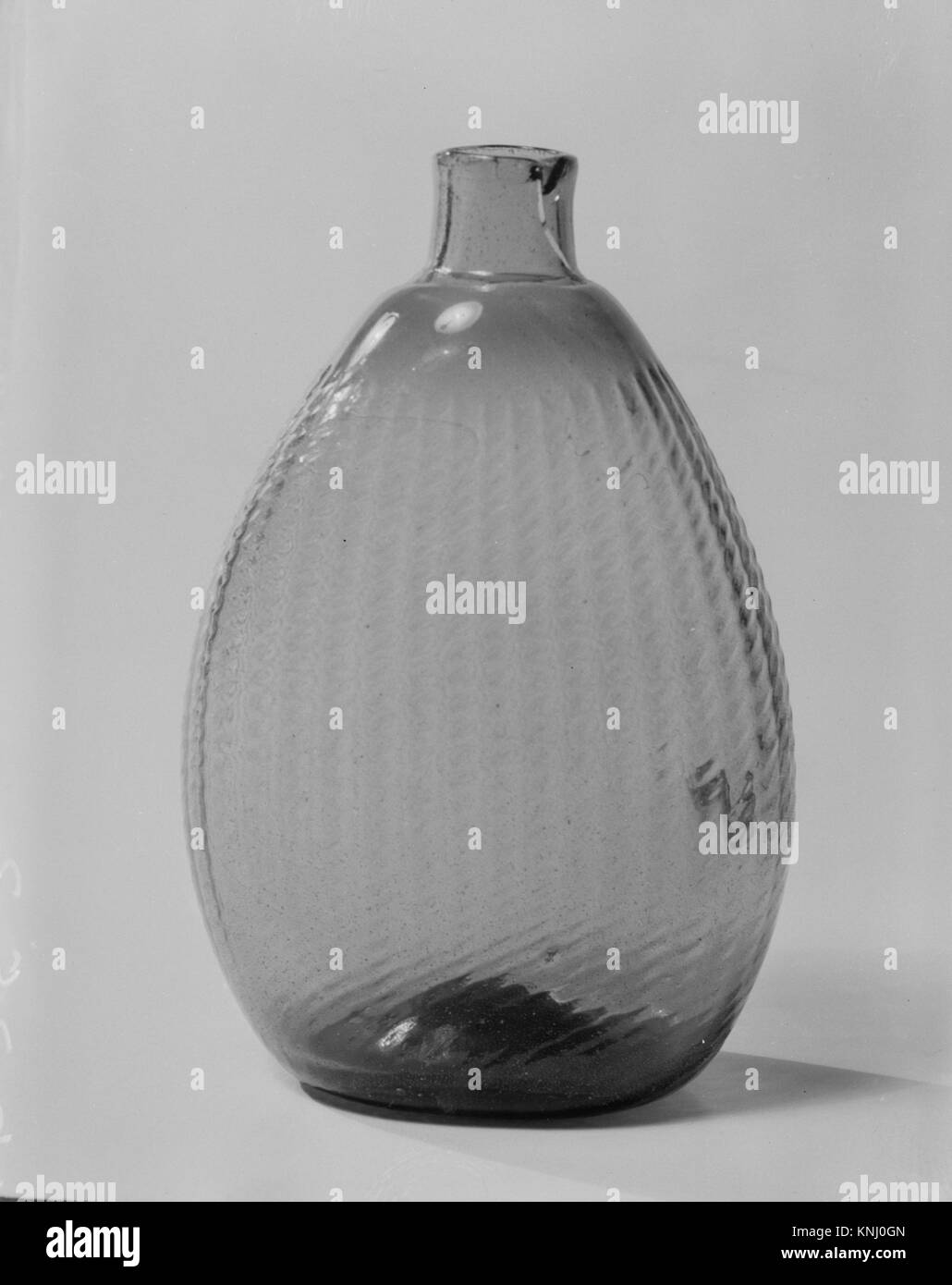 This flask, likely used for holding liquids, features intricate design ...