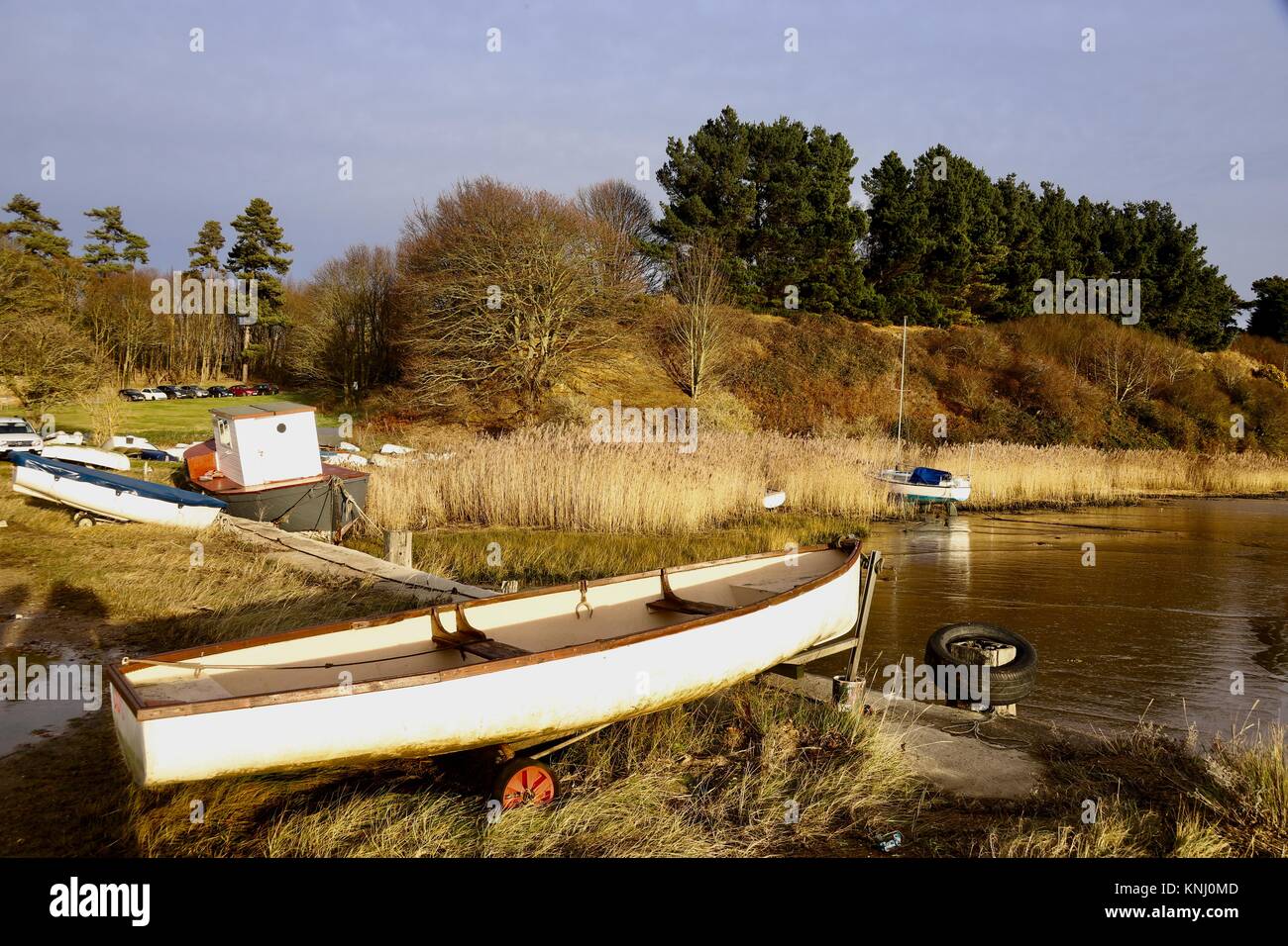 White dinghy on a trailer ashore by the river Deben at Ramsholt ...