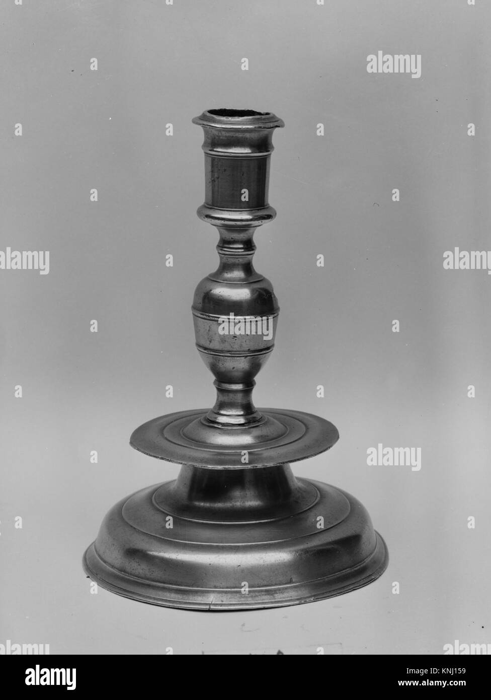 A brass candlestick from the 1600s-1700s, exemplifying historical ...