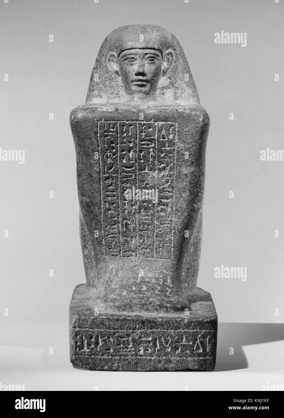 This block statue depicts Pameniuwedja, a priest of Amun, alongside his ...