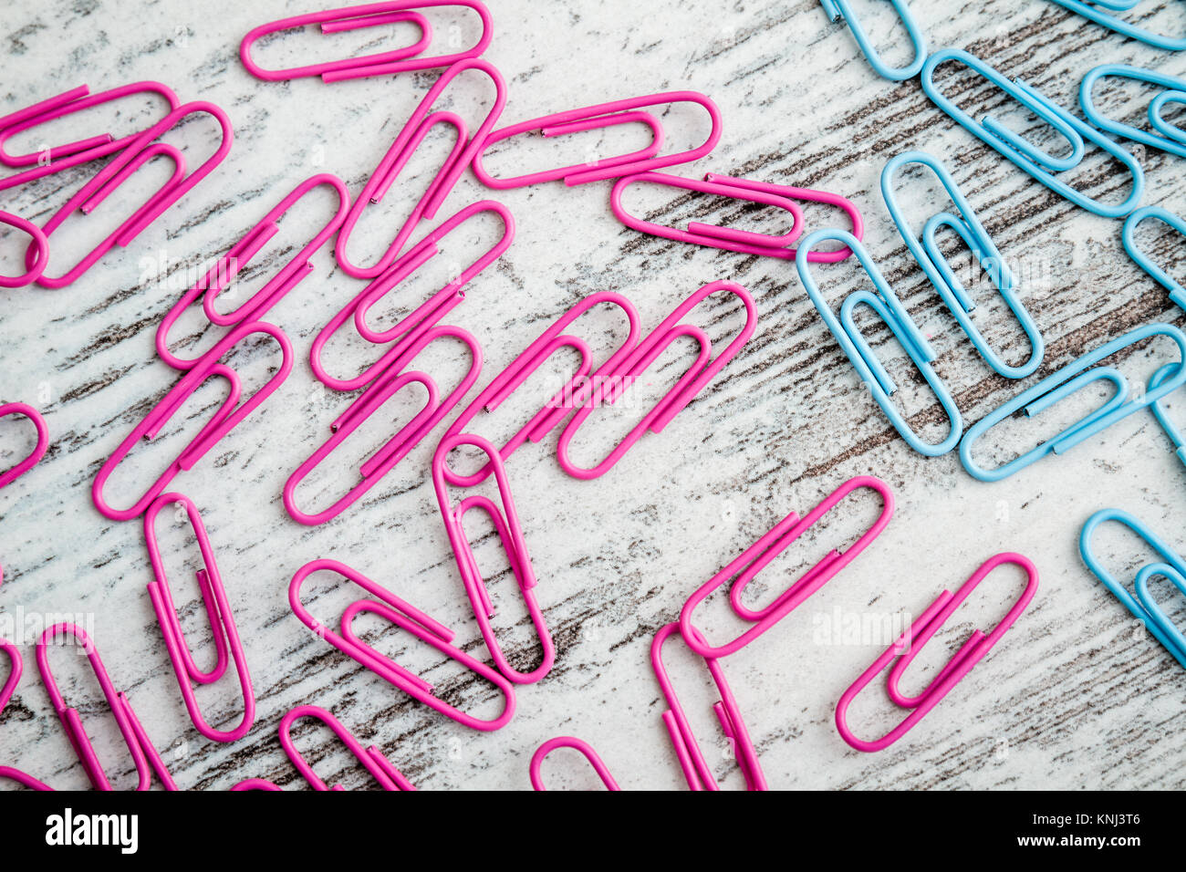 Pink and blue binder paper clips on white background Stock Photo - Alamy