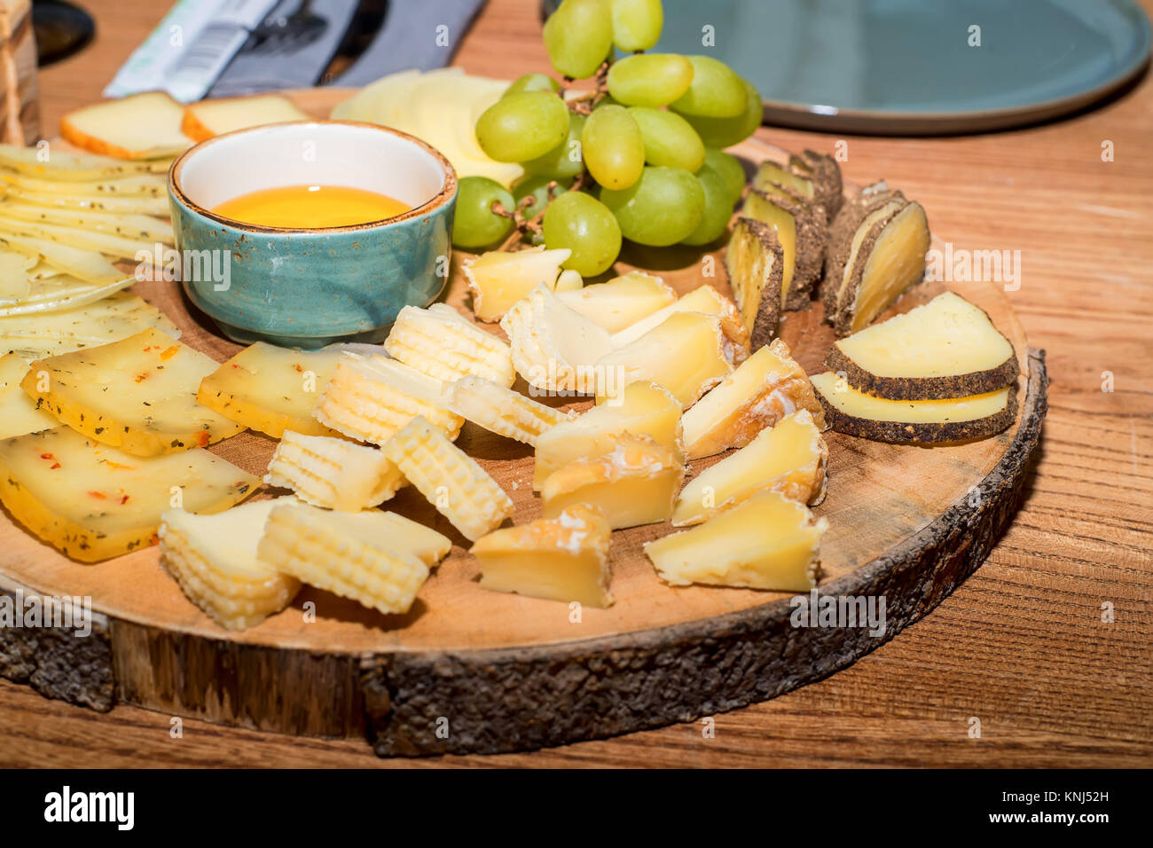 Cheese slices and pieces on plate Stock Photo - Alamy