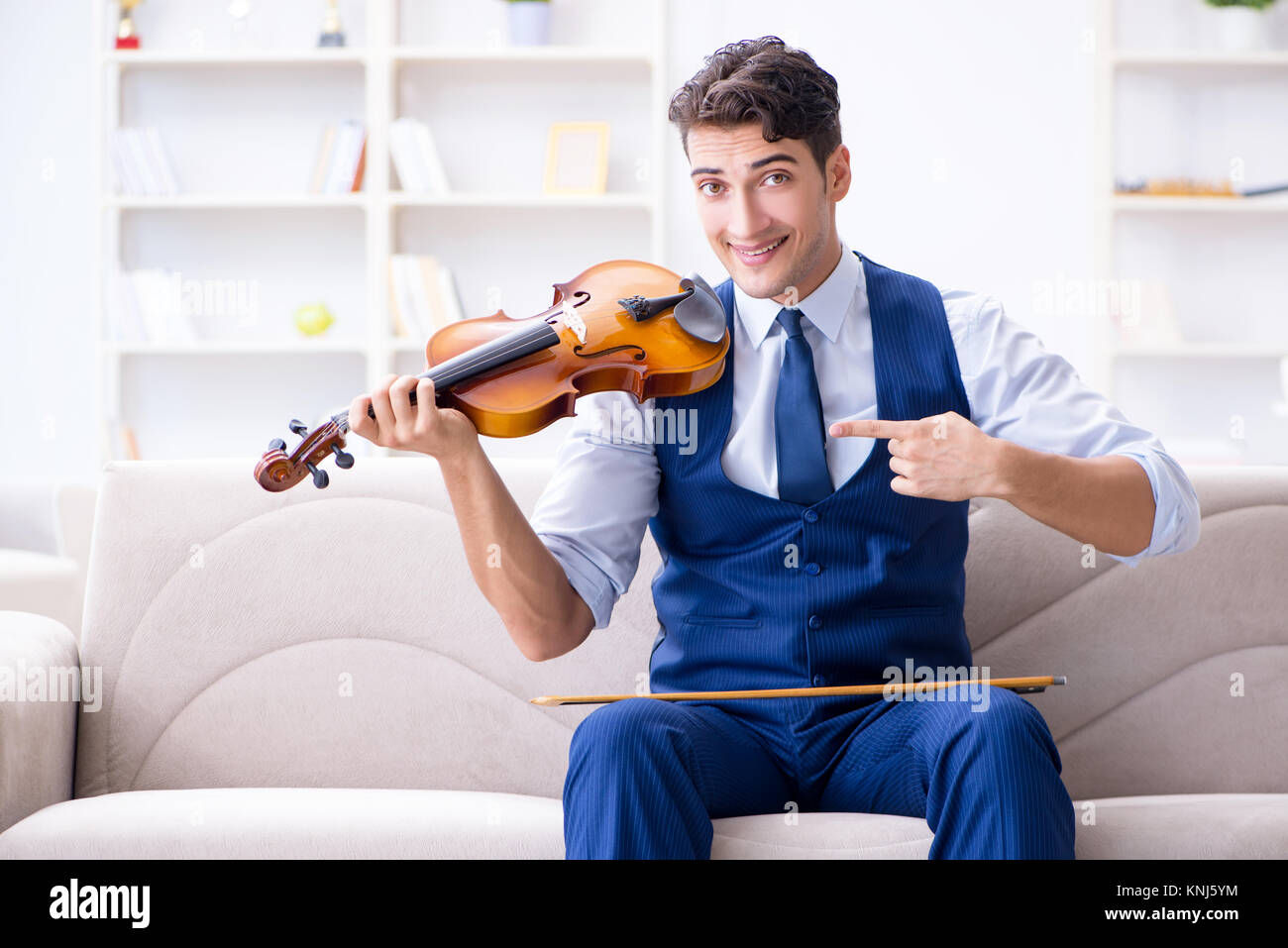 Young musician man practicing playing violin at home Stock Photo - Alamy