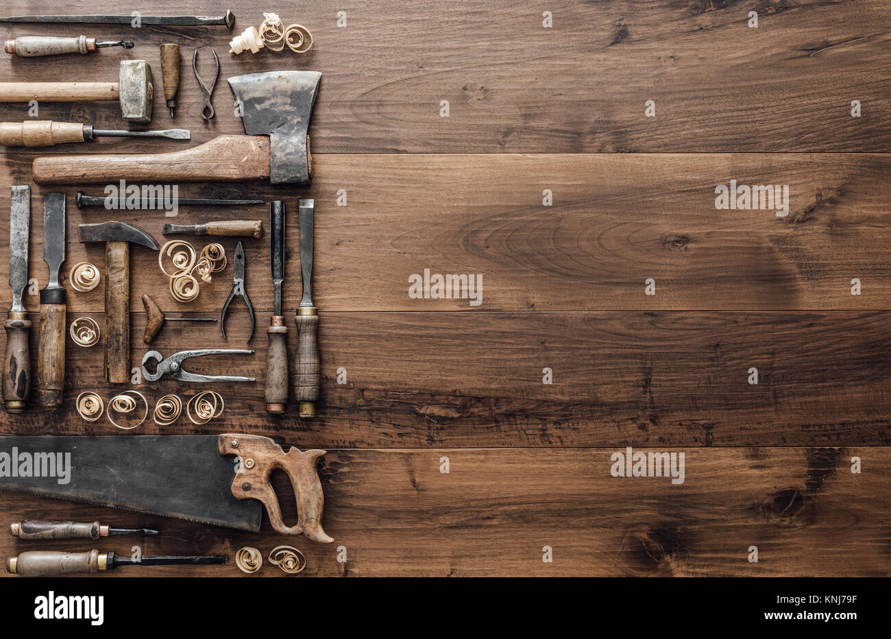 Collection of vintage woodworking tools on a rough workbench and blank ...
