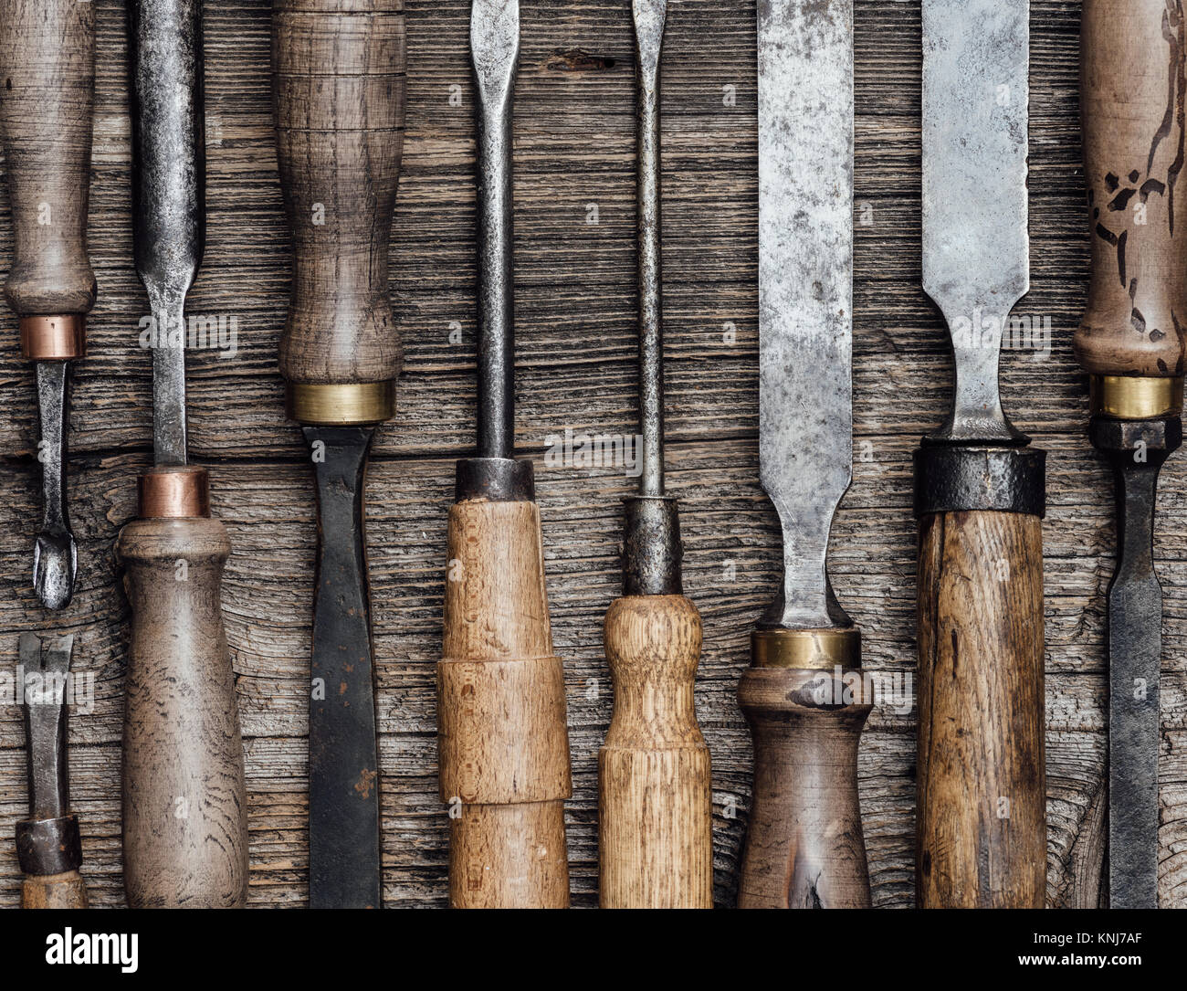 Set of used professional carving and woodworking tools on the workbench ...