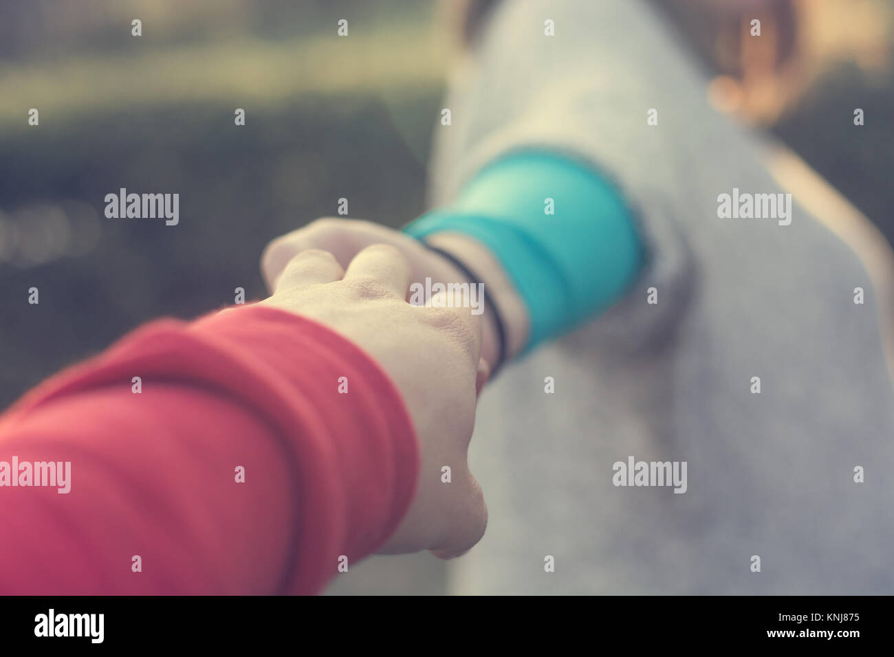 Couple female hands guiding her boyfriend Stock Photo - Alamy