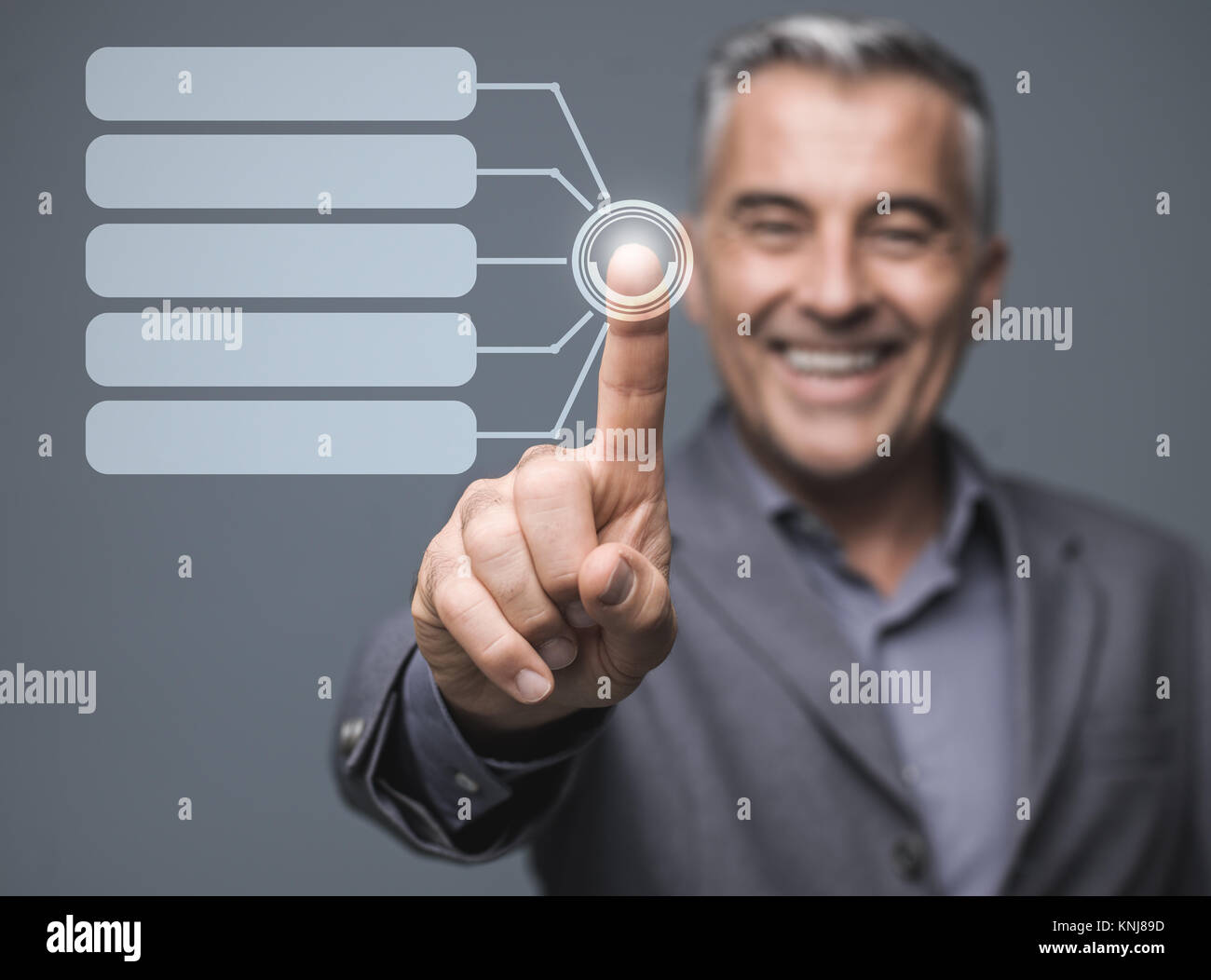 Confident businessman using a virtual touch screen interface and ...