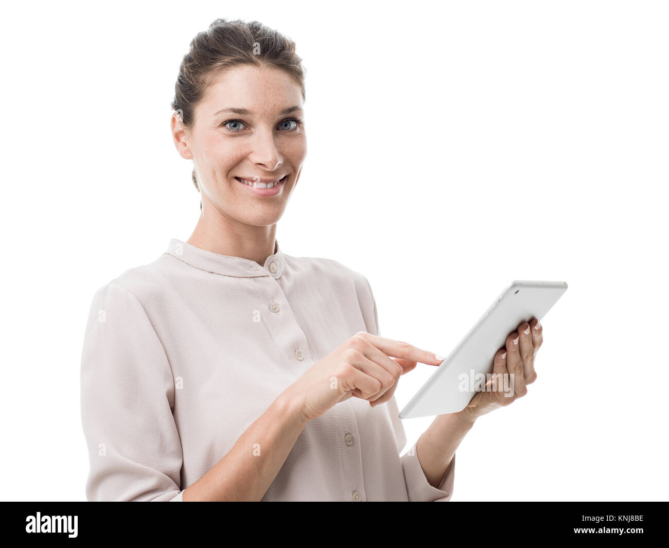 Smiling attractive woman connecting with a digital touch screen tablet ...