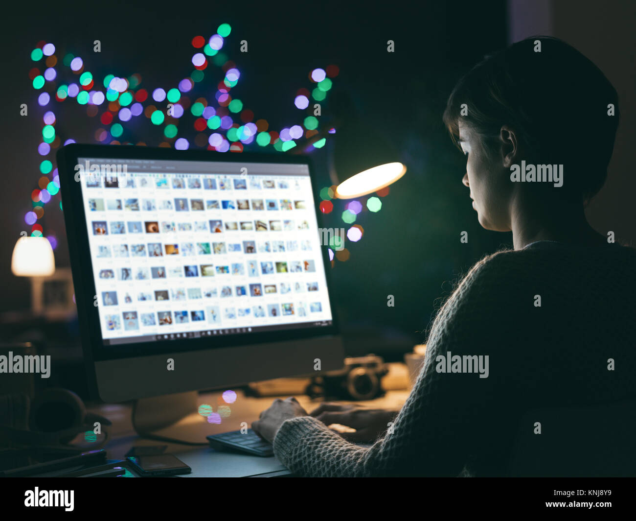 Photographer viewing pictures on the computer screen and sharing them ...