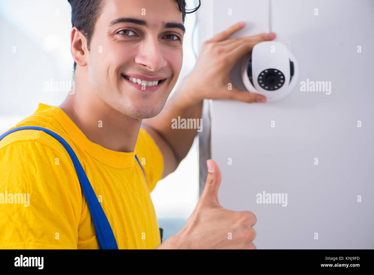 Contractor installing surveillance CCTV cameras in office Stock Photo ...
