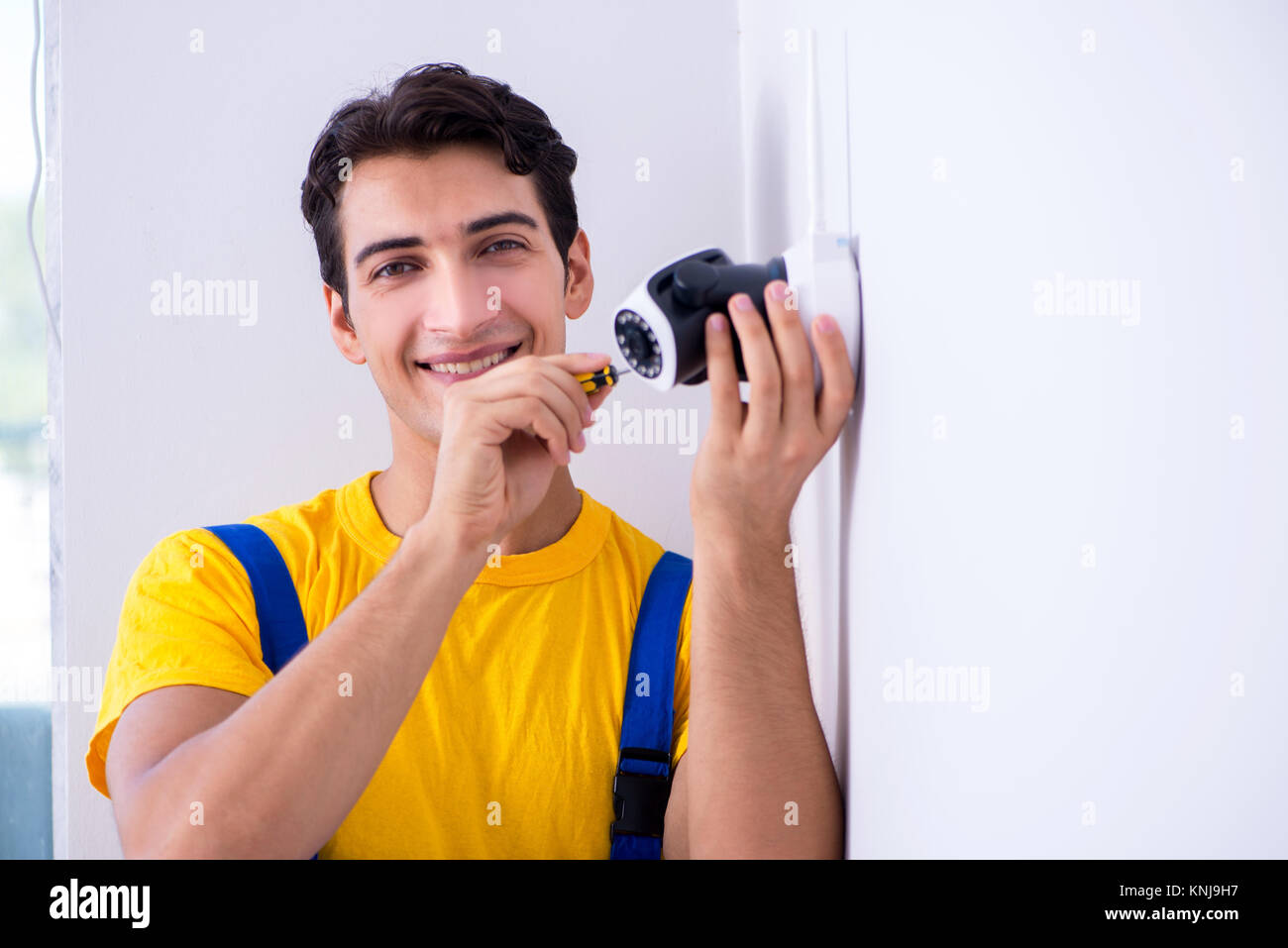 Contractor installing surveillance CCTV cameras in office Stock Photo ...