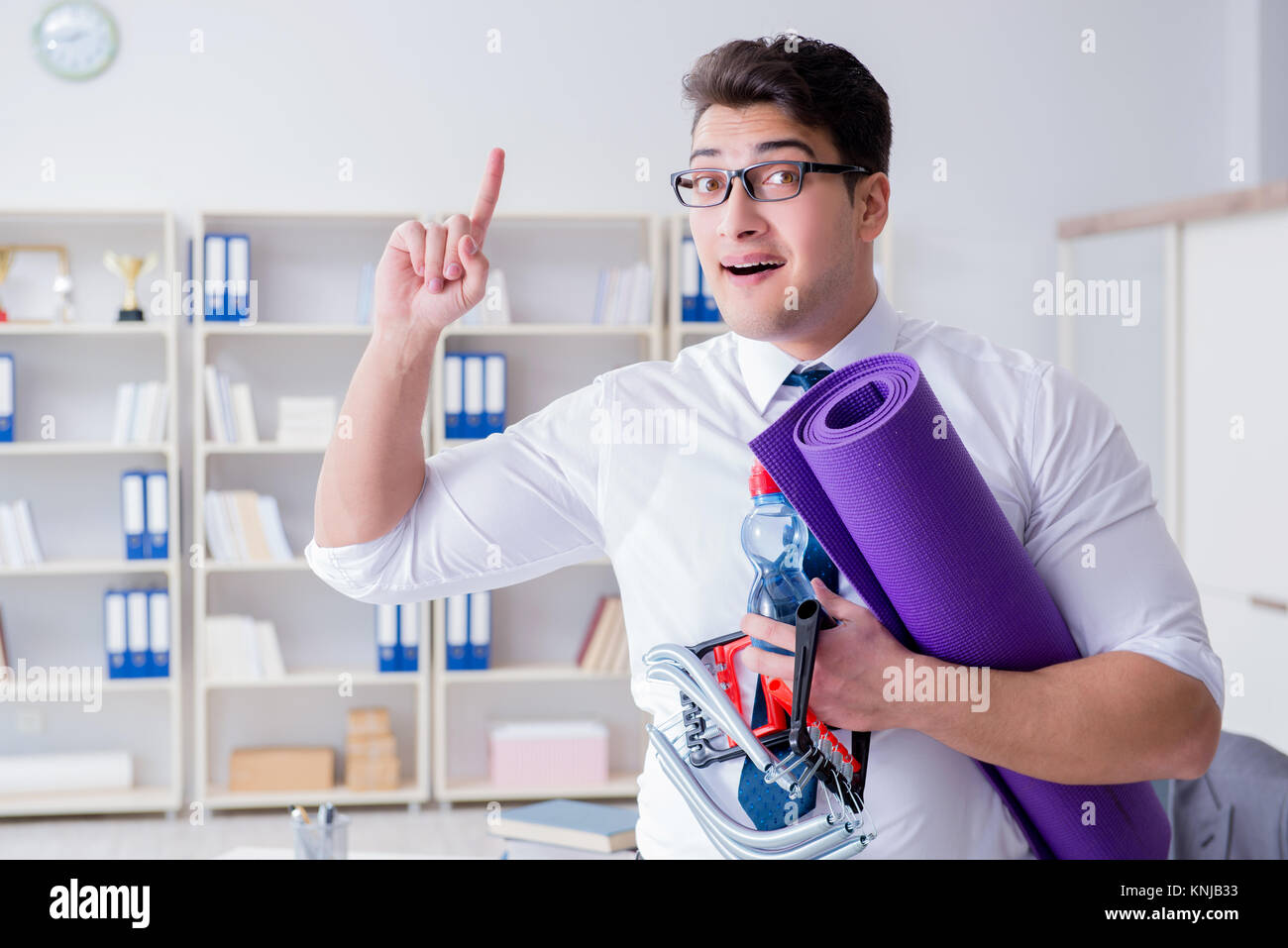 Businessman preparing to go exercising in gym Stock Photo - Alamy