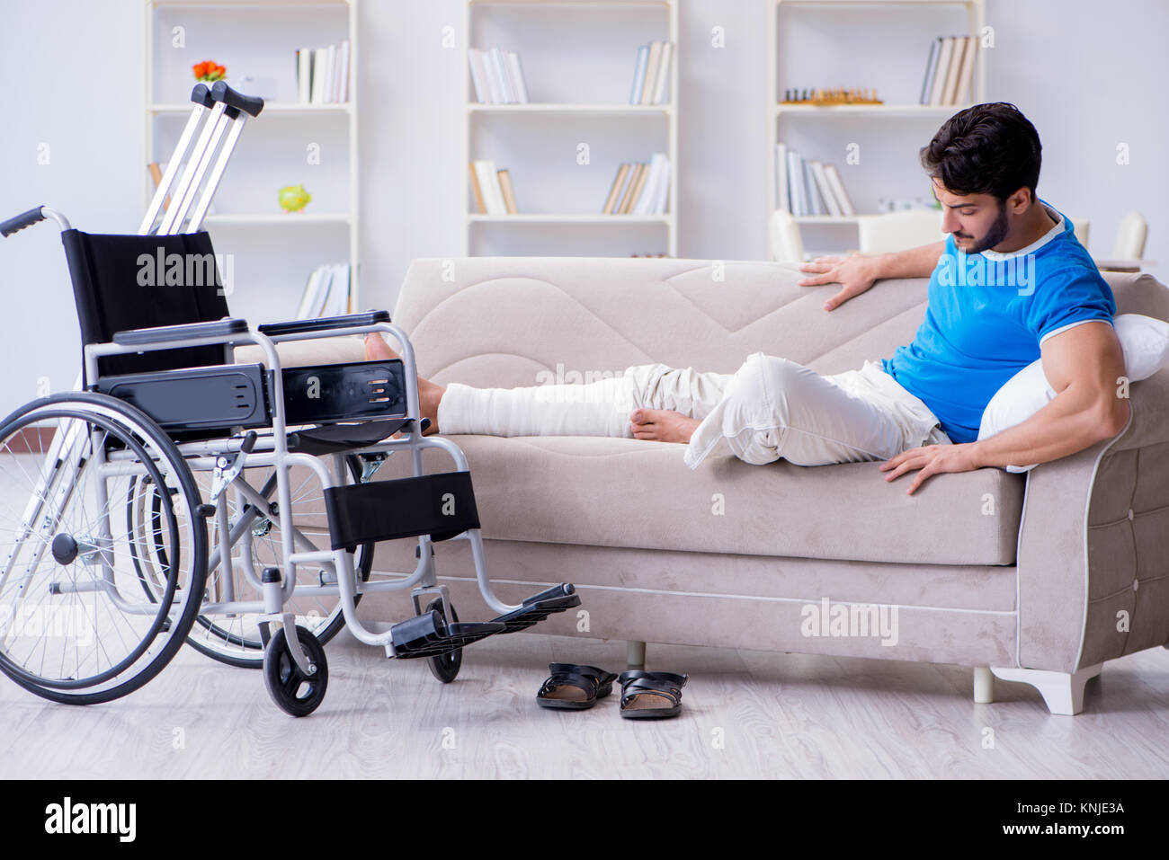 Injured young man recovering at home Stock Photo - Alamy