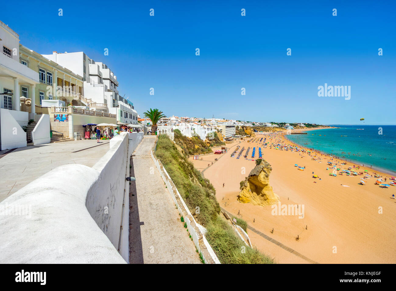 Beautiful cliffs between sandy beach and white architecture of ...