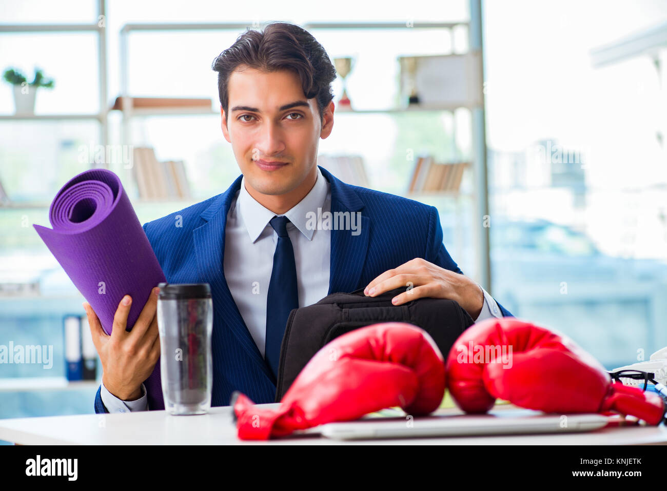 Man with boxing gloves in the office Stock Photo - Alamy