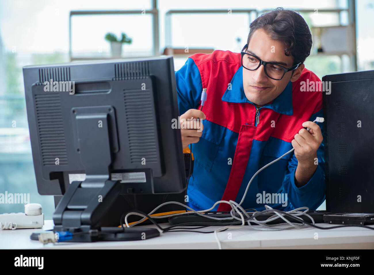 Computer repairman working on repairing computer in IT workshop Stock ...