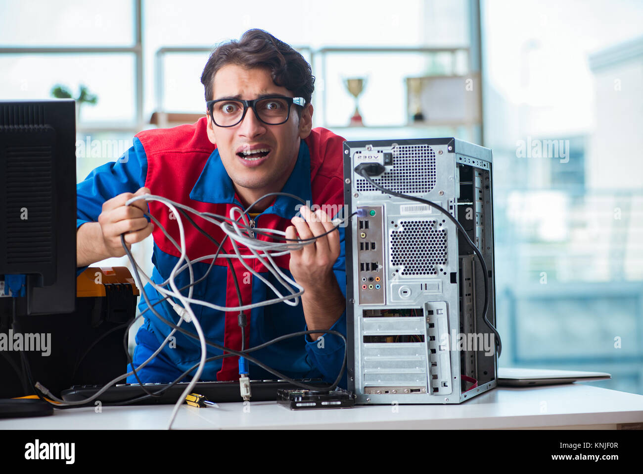 Computer repairman working on repairing computer in IT workshop Stock ...