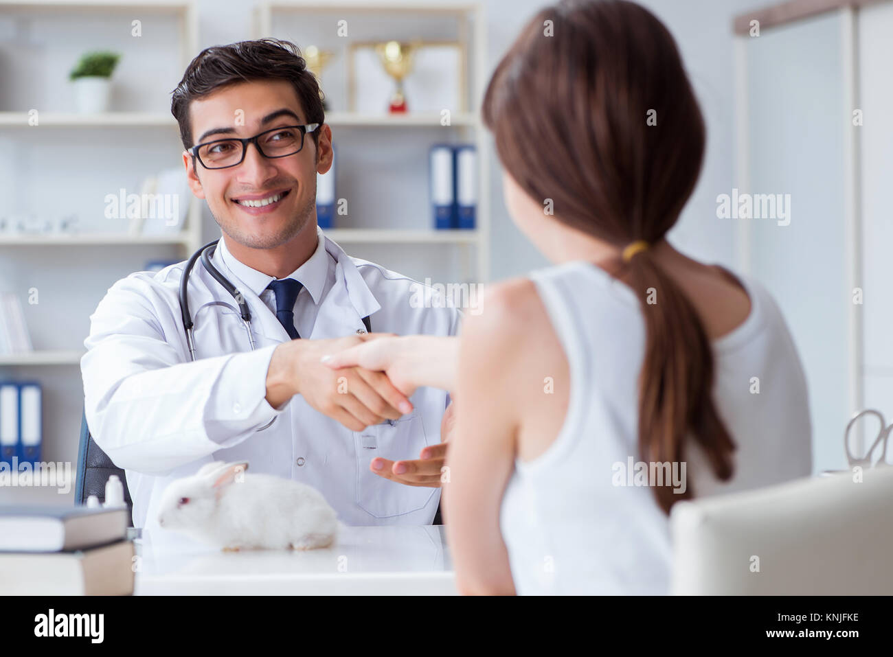 Woman with pet rabbit visiting vet doctor Stock Photo - Alamy
