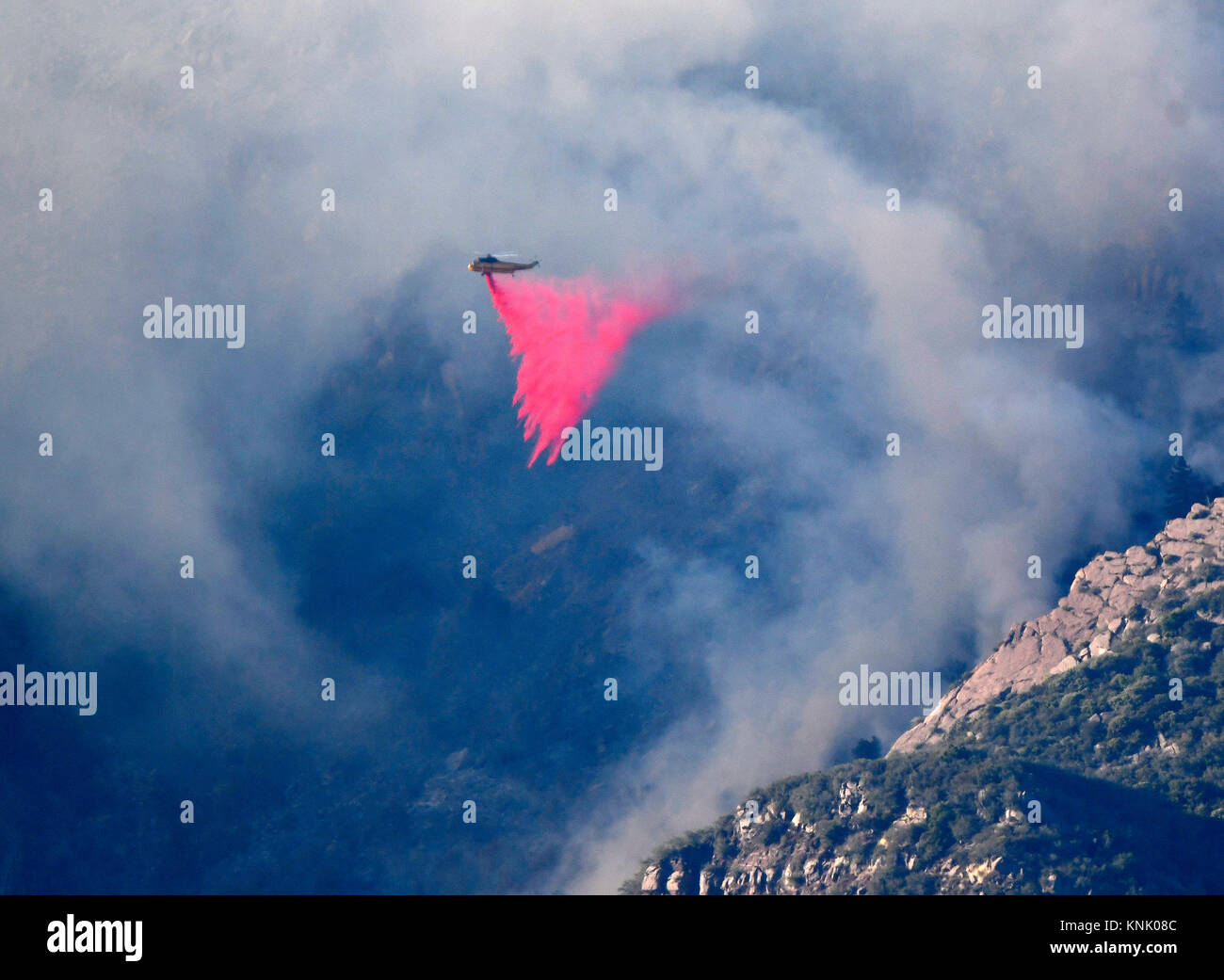 Ca. 12th Dec, 2017. Fire helicopters make Phos-Chek drops to get ...