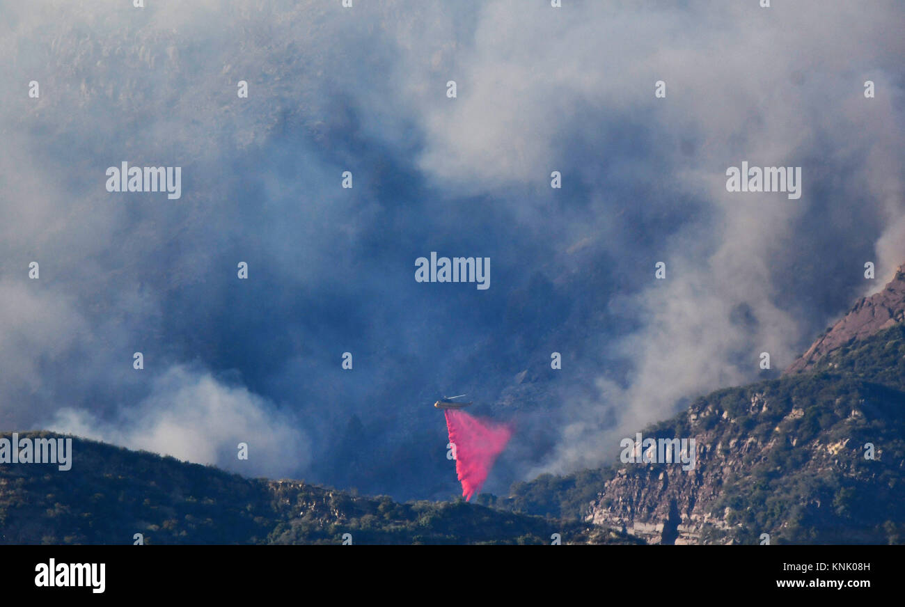 Ca. 12th Dec, 2017. Fire helicopters make Phos-Chek drops to get ...