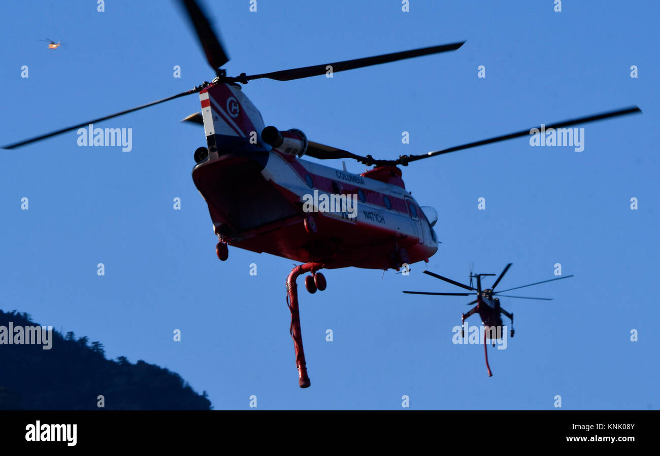 Ca. 12th Dec, 2017. Fire helicopters make Phos-Chek drops to get ...