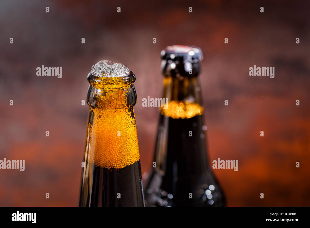 Beer overflow from a just opened beer bottle on dark background. Food ...