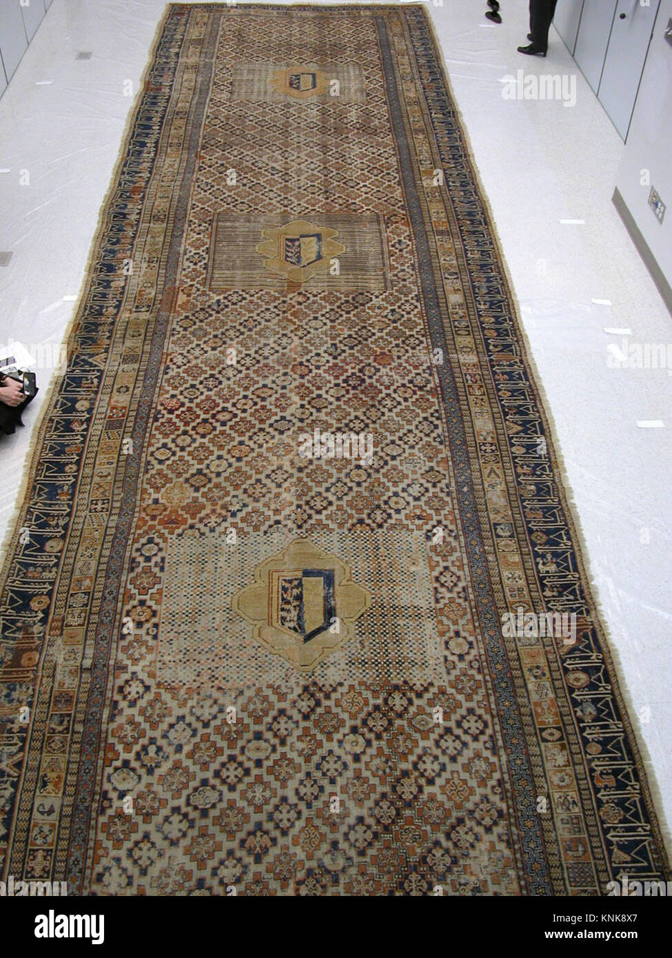 This 15th-century Spanish carpet with a coat of arms is a wool textile ...