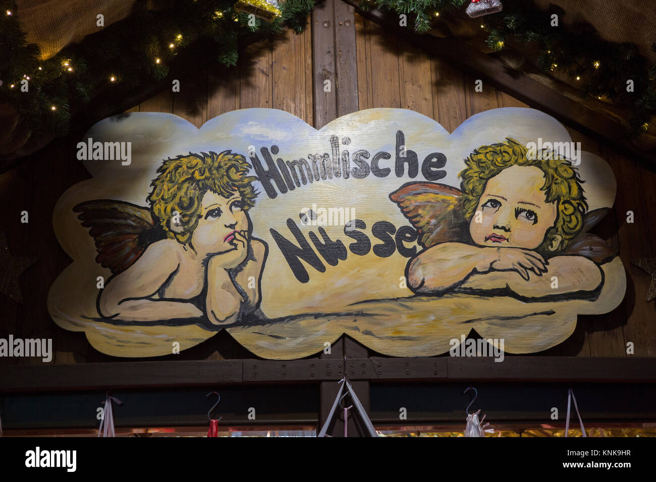 A sign above a stall reads 'Heavenly nuts' and depicts two angels. The ...