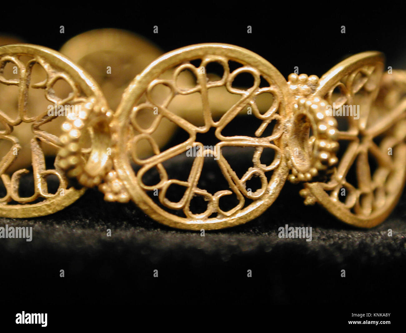 An 11th-century Iranian gold earring with detailed filigree and ...