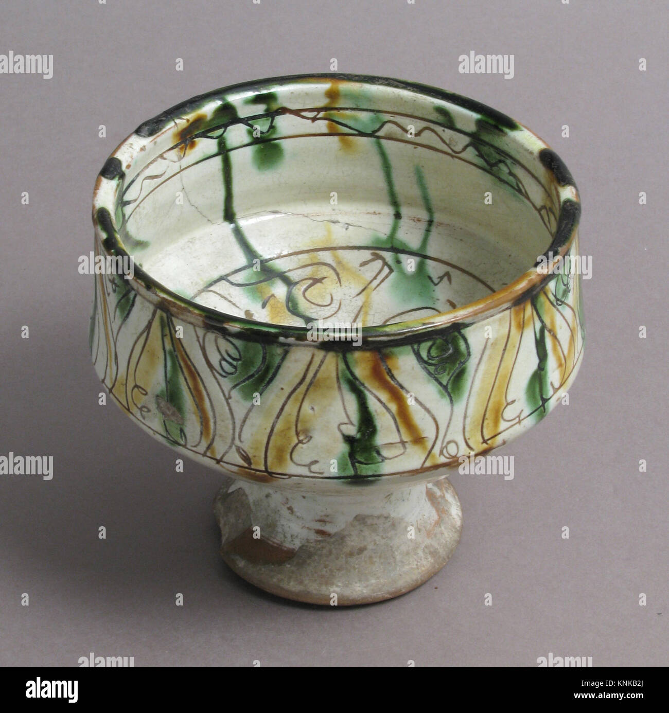 A late 14th-century Cypriot pottery cup with footed base, glazed ...