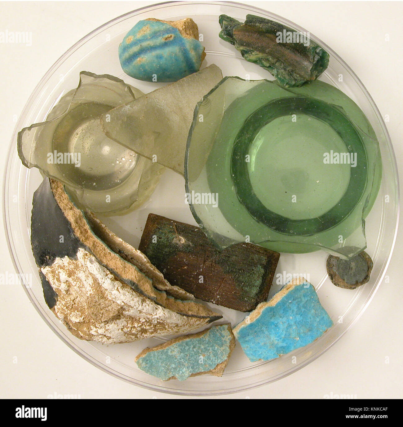 Fragments of Glass, wood, copper alloy, mortar and glazed earthenware ...