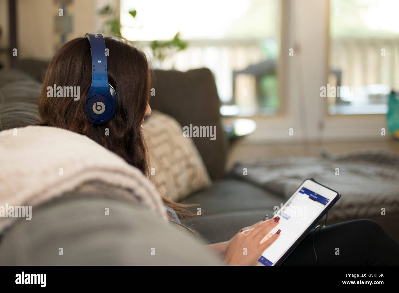 Attractive young woman using modern technology while sitting on the ... Attractive young woman using modern technology while sitting on the ...