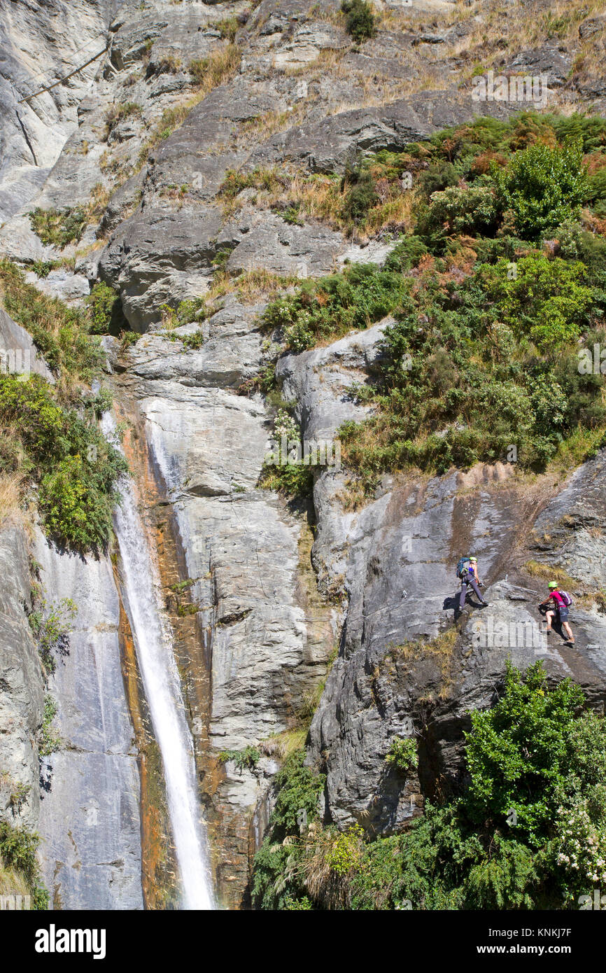 Climbers on the Wildwire via ferrata route at Twin Falls in Wanaka ...