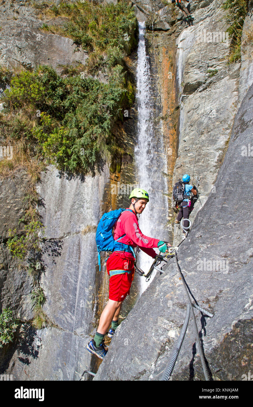 Climbers on the Wildwire via ferrata route at Twin Falls in Wanaka ...