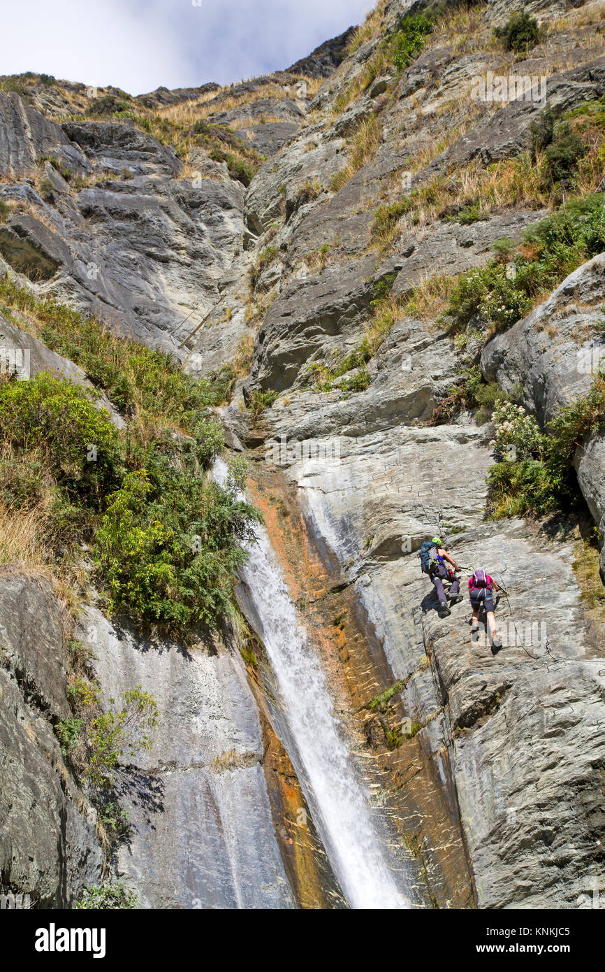 Climbers on the Wildwire via ferrata route at Twin Falls in Wanaka ...