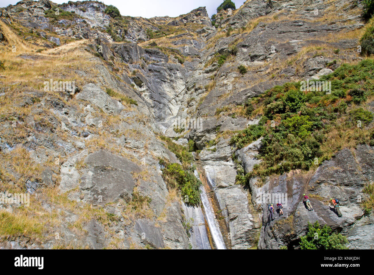 Climbers on the Wildwire via ferrata route at Twin Falls in Wanaka ...