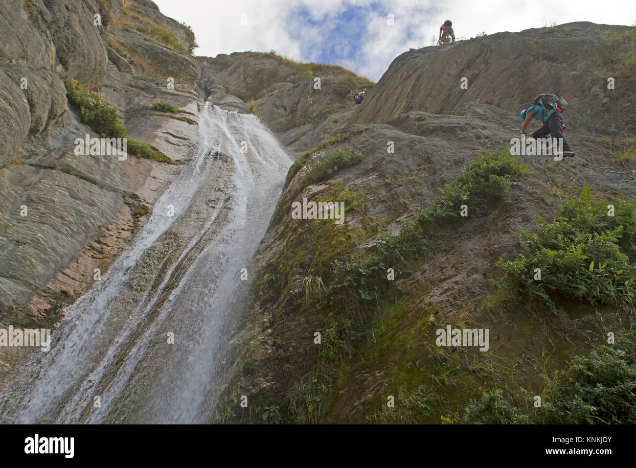 Climbers on the Wildwire via ferrata route at Twin Falls in Wanaka ...