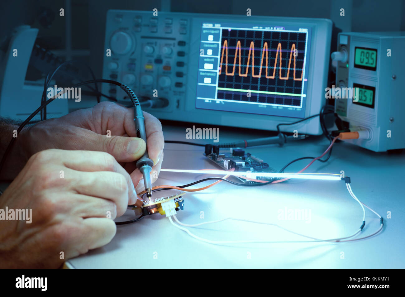 Tech tests electronic equipment in service facility Stock Photo - Alamy