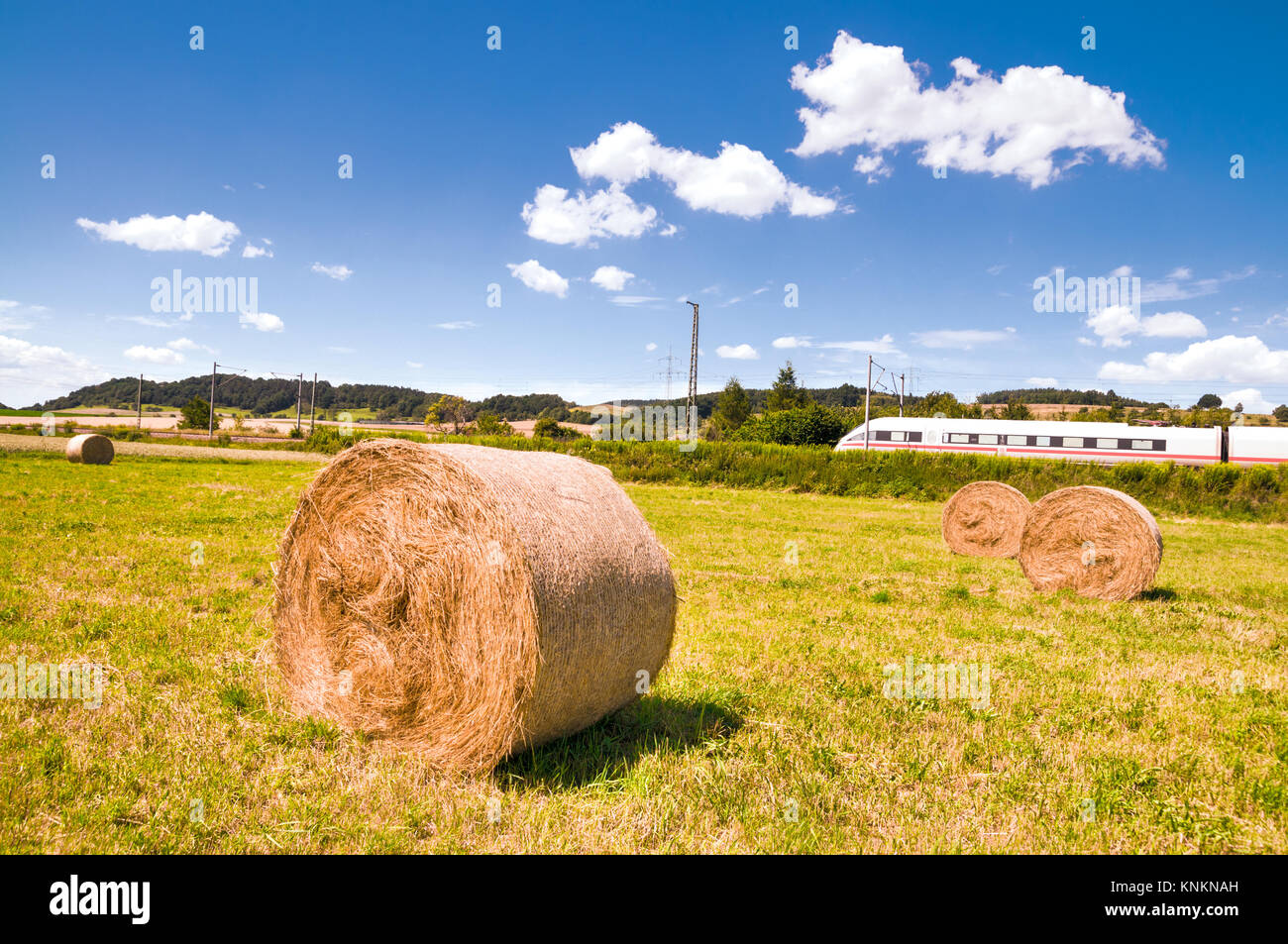 Hay rolls on the field and a passing bullet train Stock Photo - Alamy