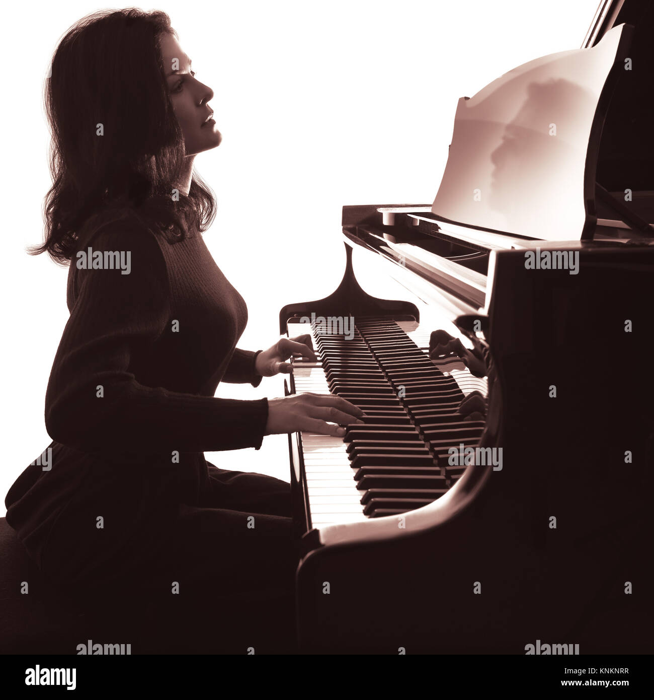 Young musician plays the grand piano, sepia toning Stock Photo - Alamy