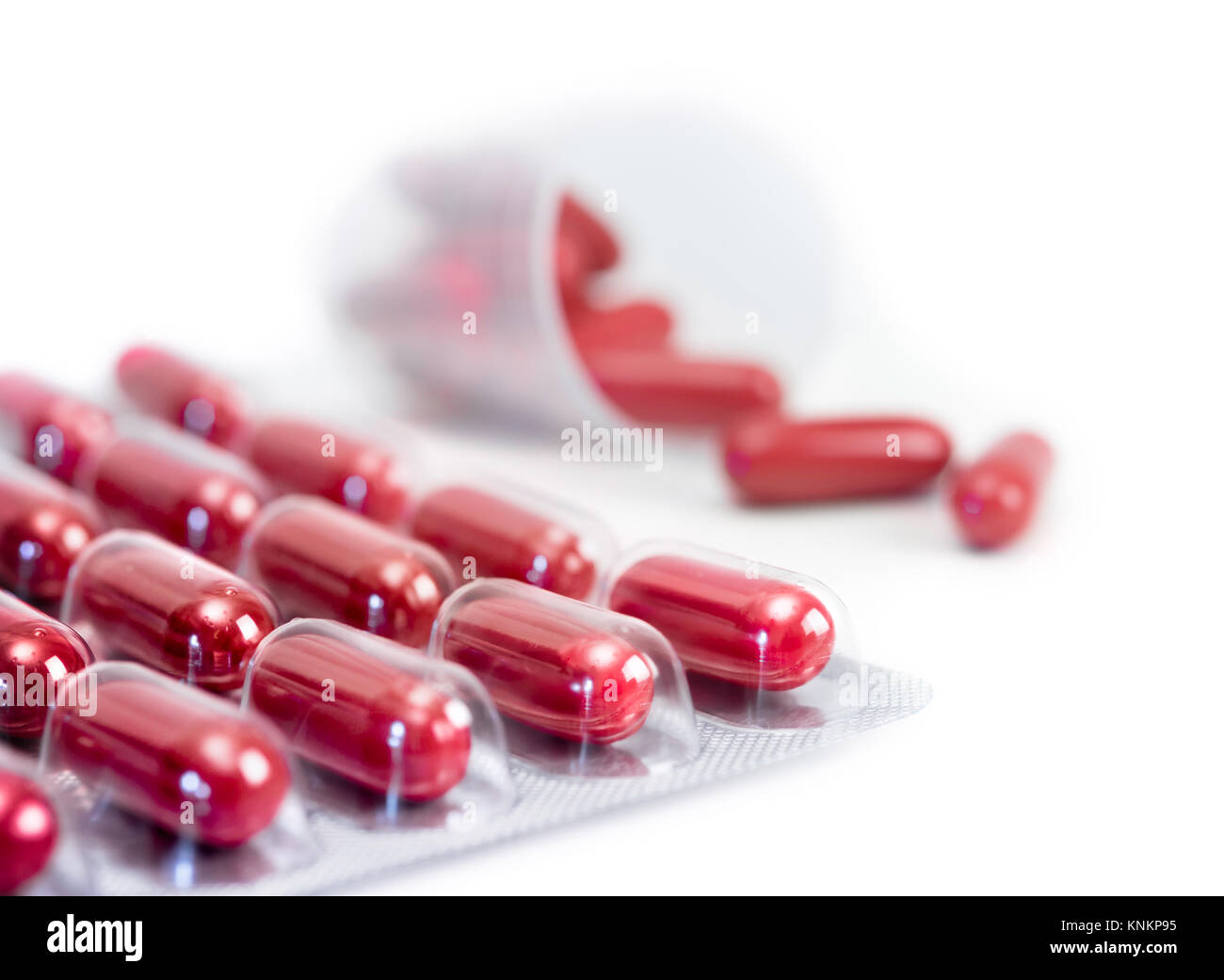 Closeup on dark red capsules with medication on white background Stock ...