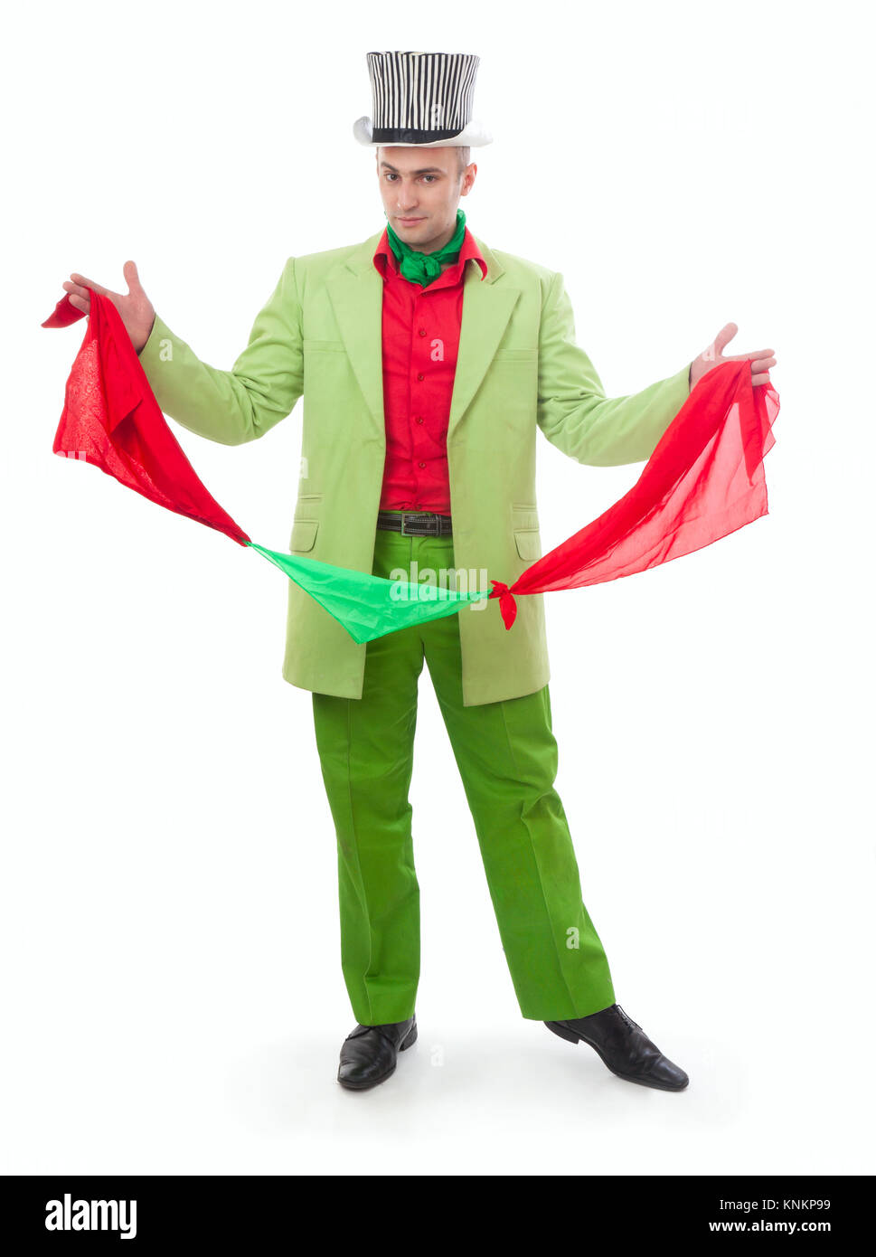 Funny magician in a green suit on a white background Stock Photo - Alamy