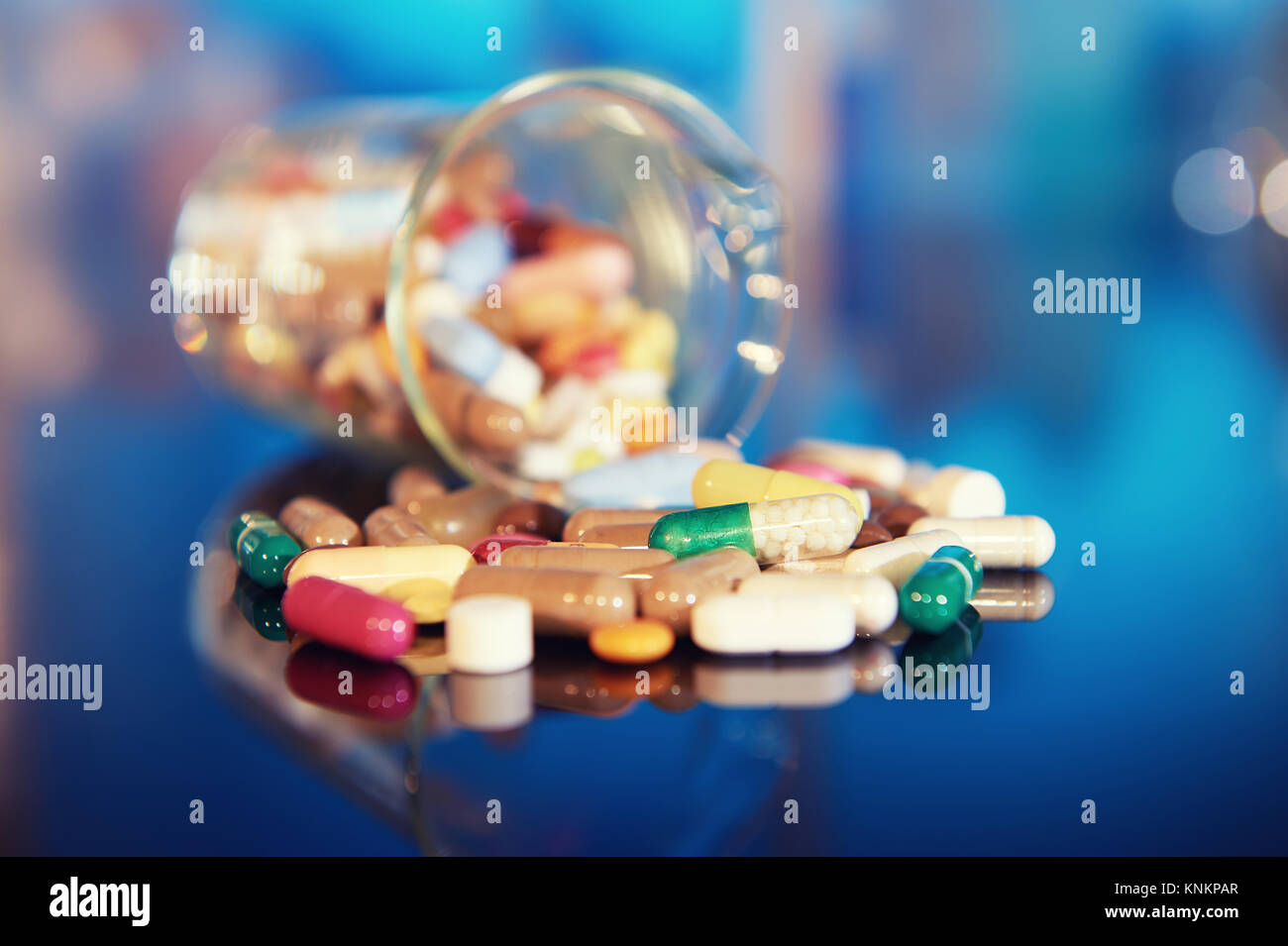 Assorted pills or capsules with medications on abstract dark background ...