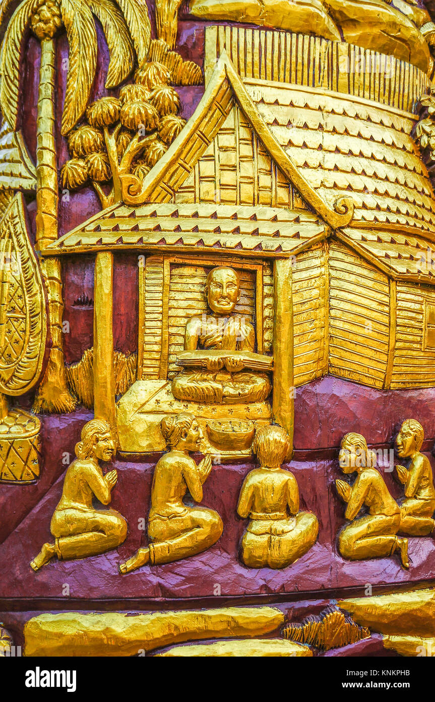 Wooden sculpture of monk teaching Buddhists, painted with gold to ...