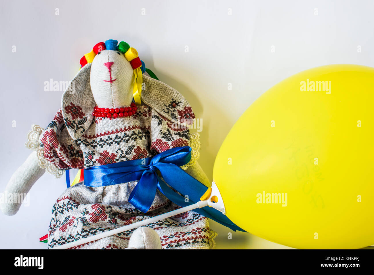 The doll is a guard in a national costume with ribbons and a yellow ...