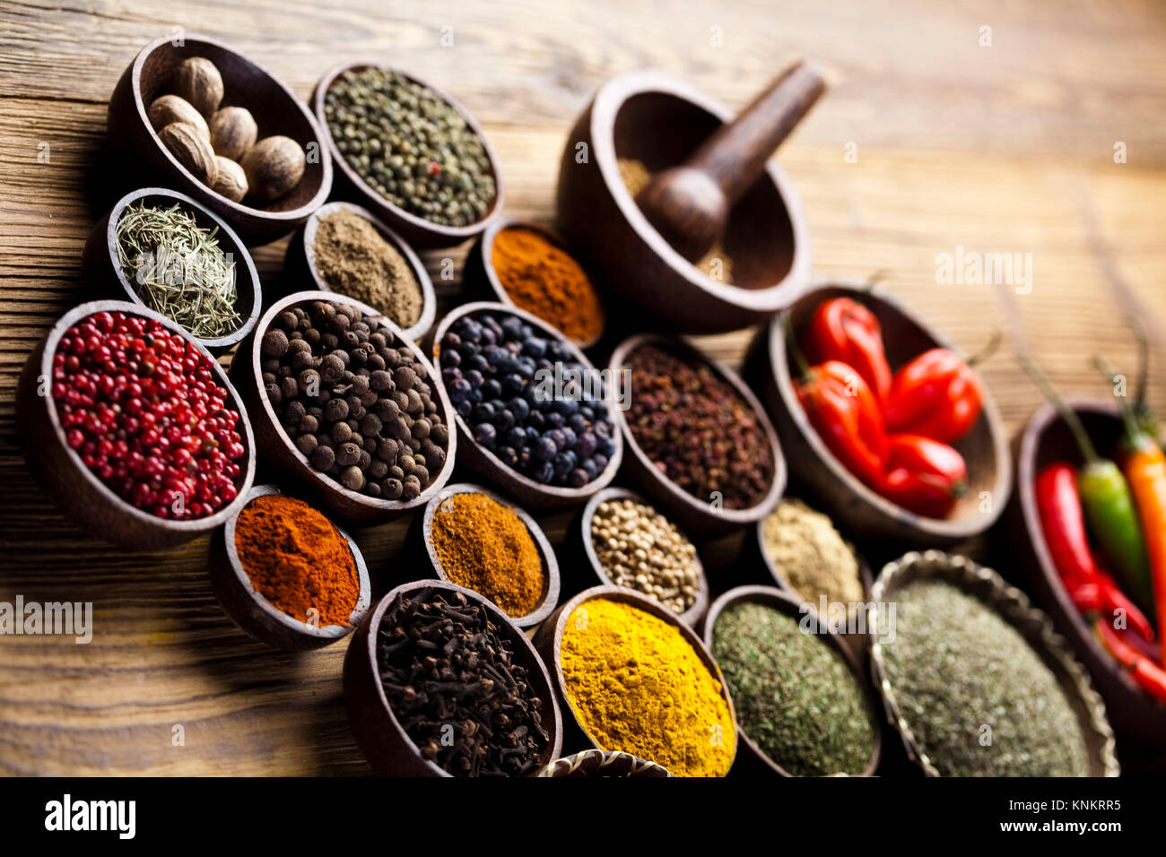 Assortment of spices in wooden bowl background Stock Photo - Alamy